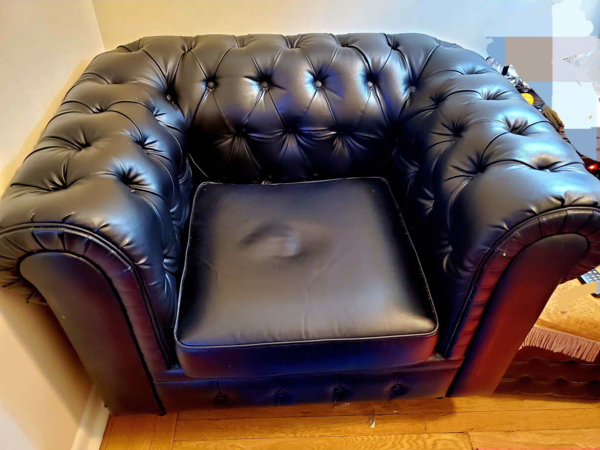 Arm tufted bonded leather accent chair in black